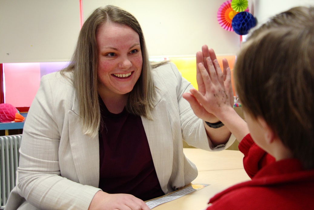 Teacher interacting with a young student